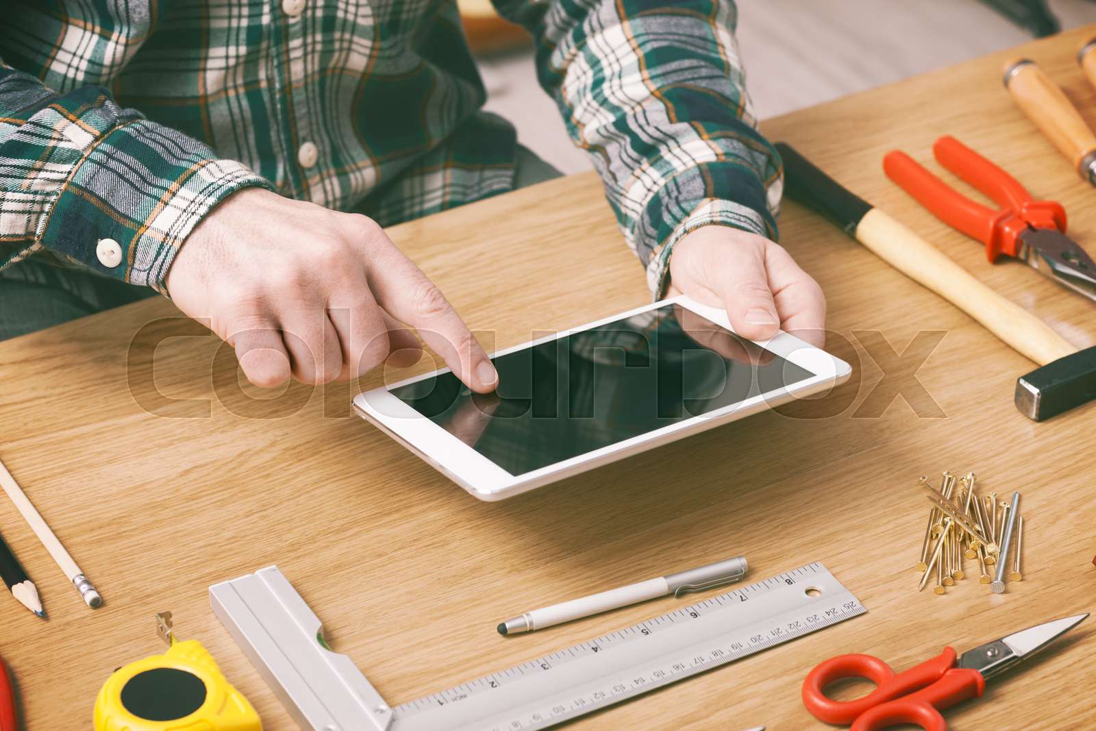 Craftsman working on a DIY project with his tablet | Stock image ...
