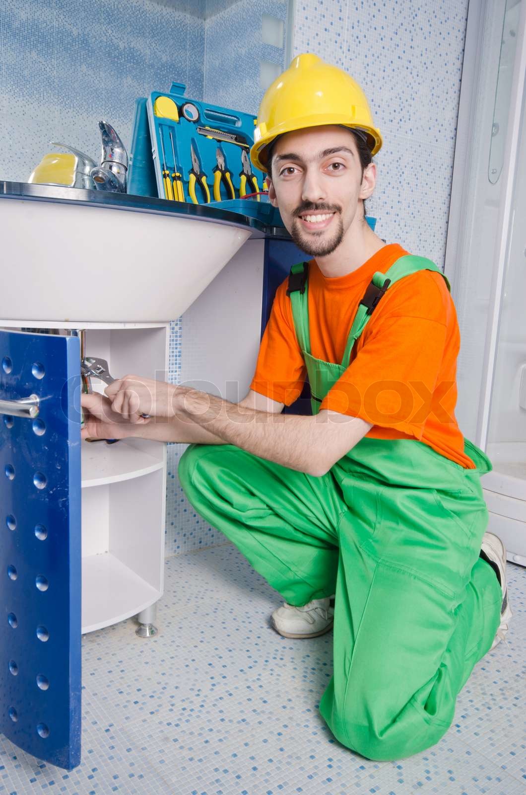 Plumber working in the bathroom | Stock image | Colourbox