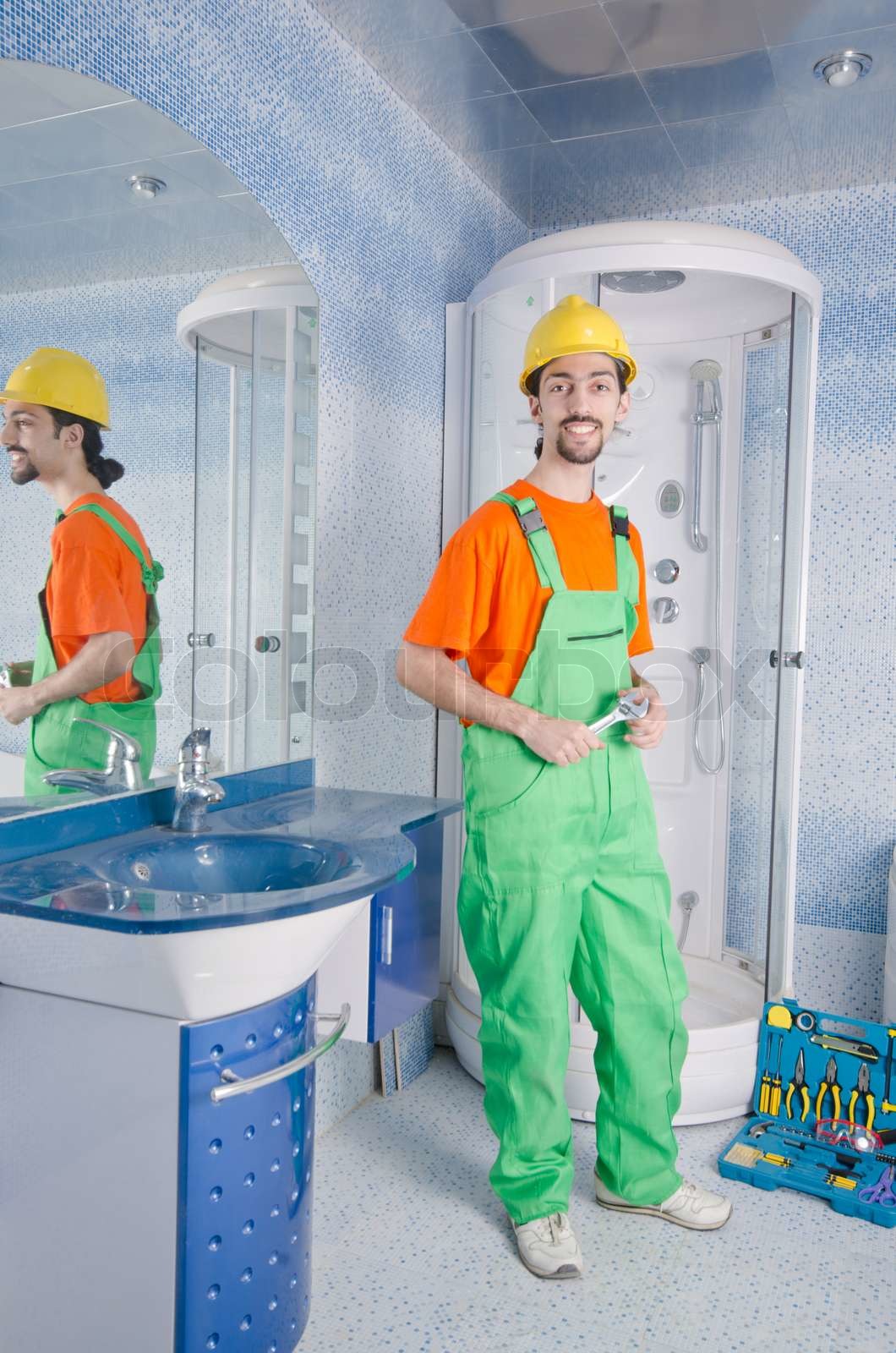 Plumber working in the bathroom | Stock image | Colourbox