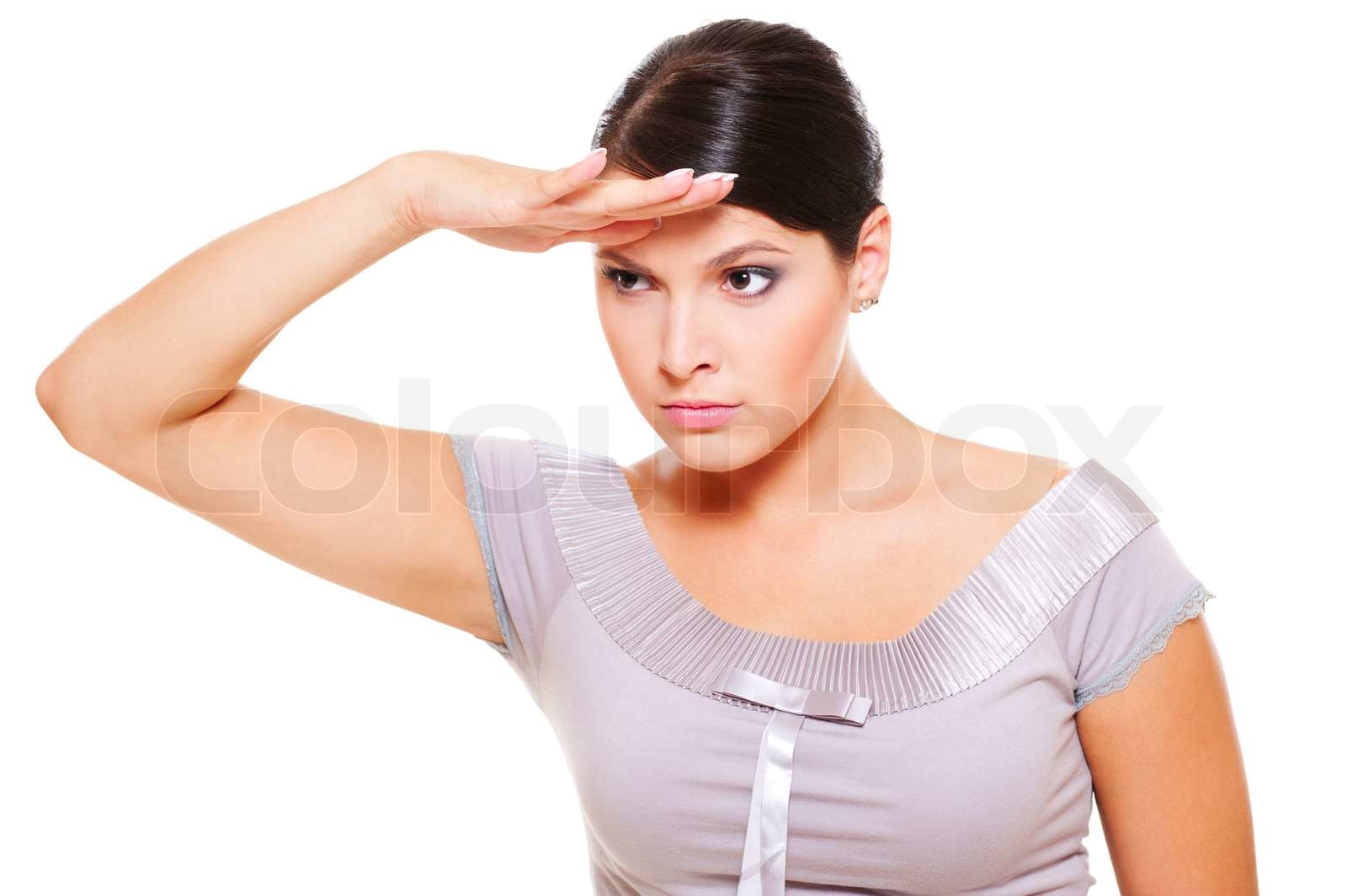 serious woman looking forward and having put her palm to forehead ...