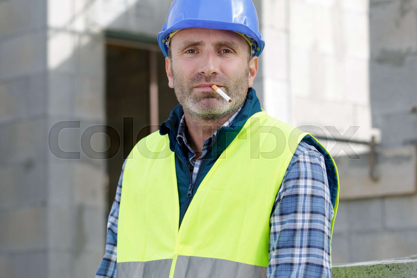 portrait of a builder smoking cigarette | Stock image | Colourbox