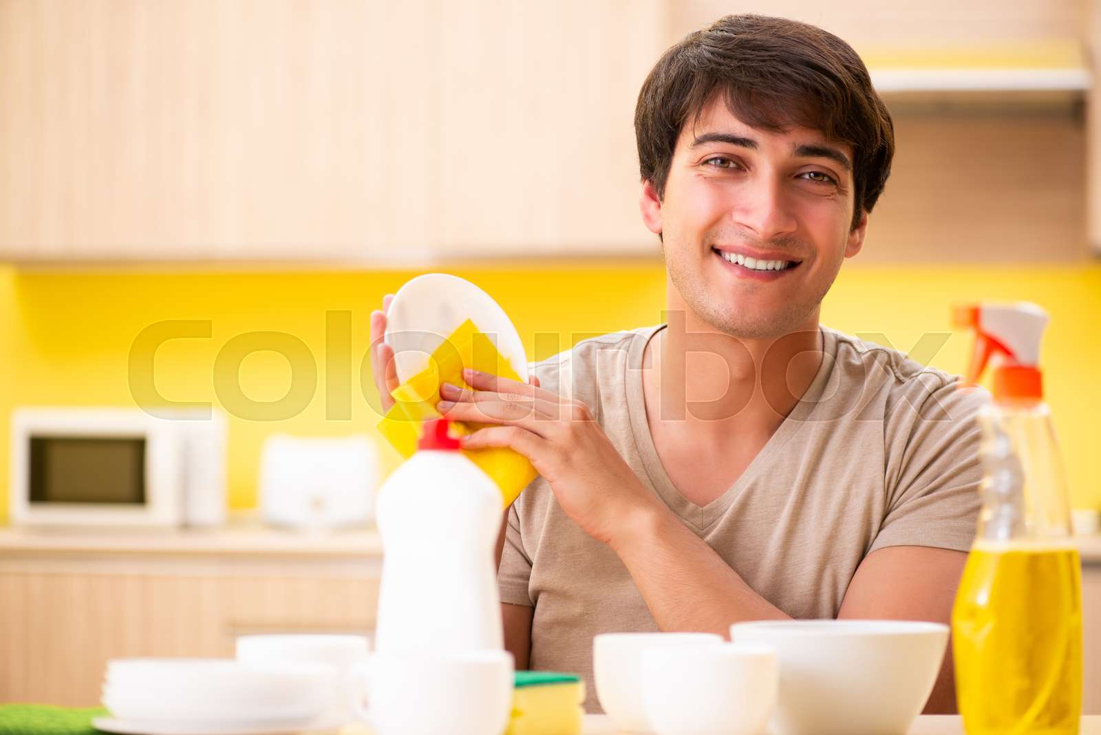 Man washing dishes at home | Stock image | Colourbox