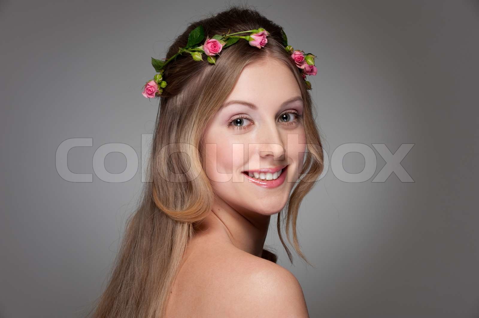 graceful young woman with roses on her head | Stock image | Colourbox