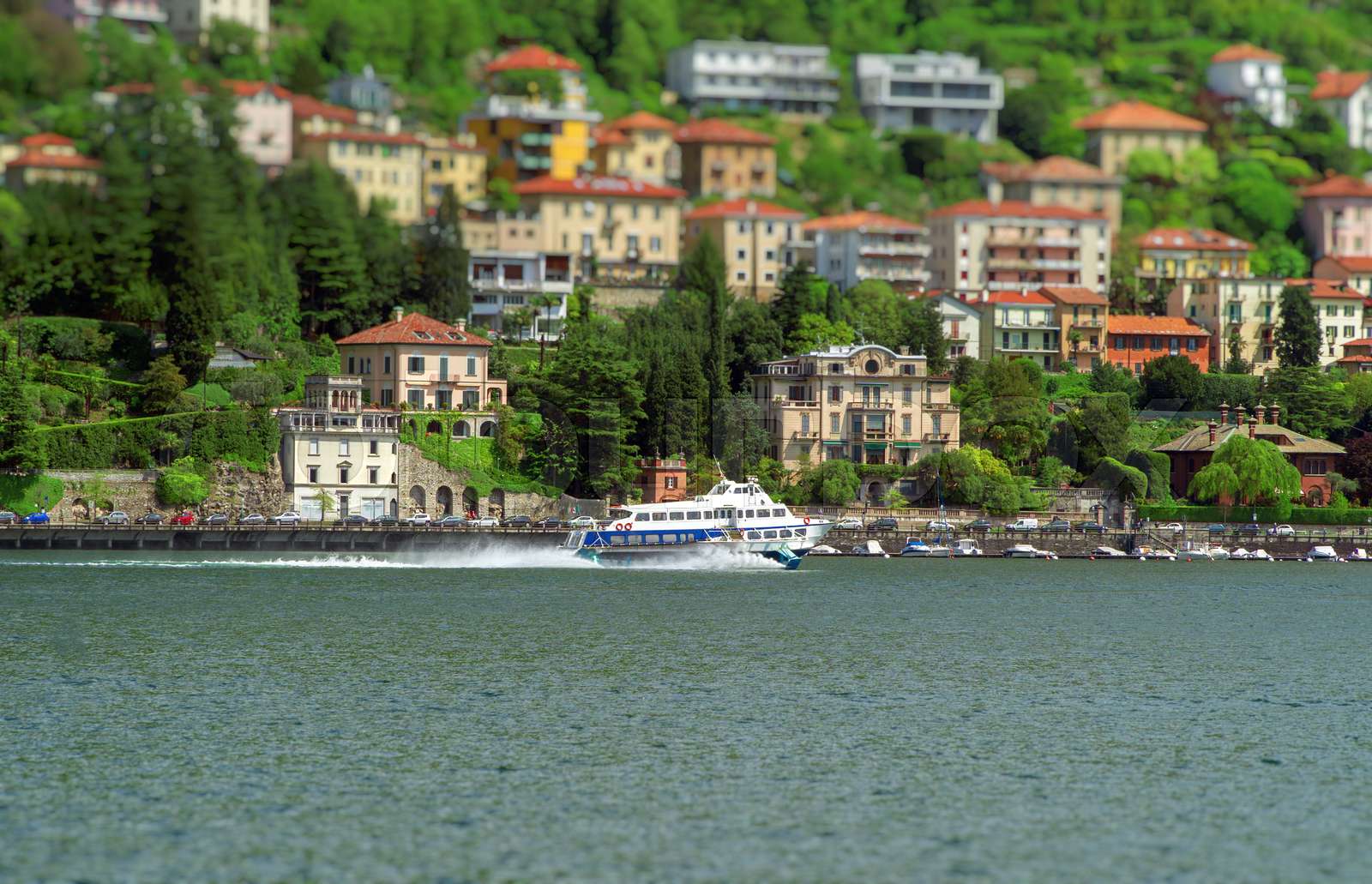 High-speed sightseeing ship sails on Lake Como. | Stock image | Colourbox