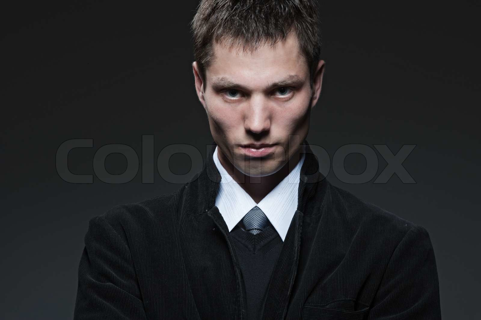 portrait of serious man over dark background | Stock image | Colourbox