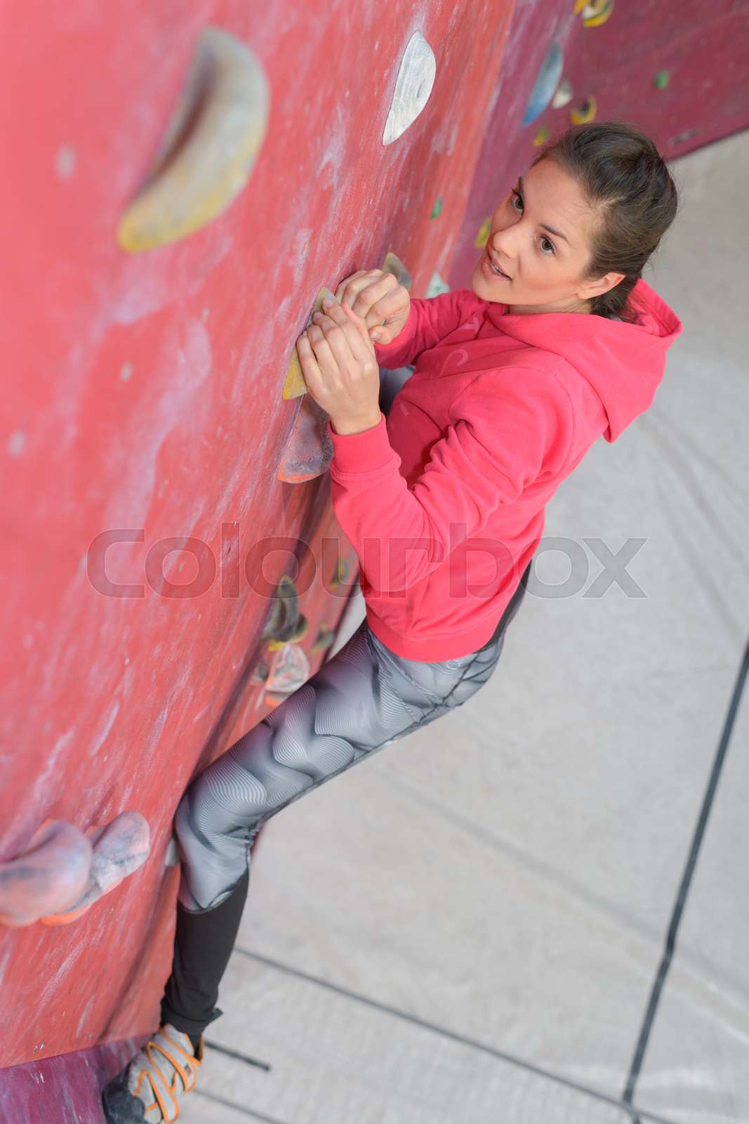 woman ascending indoor climbing wall | Stock image | Colourbox