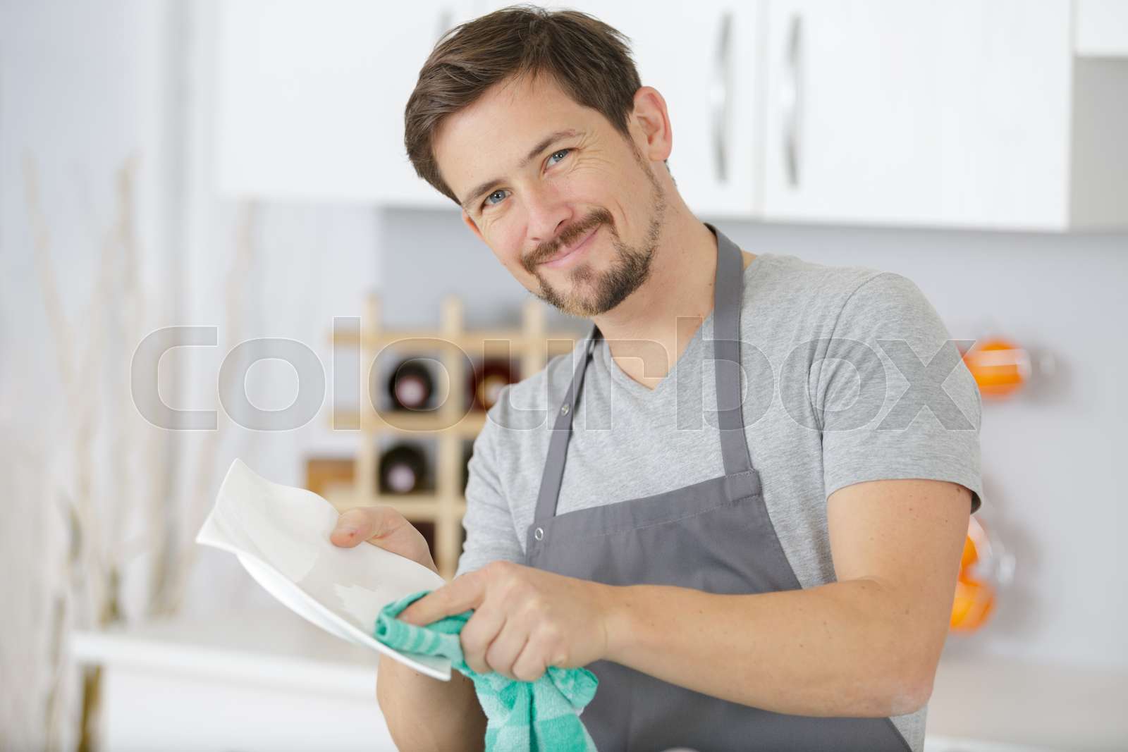 young man washing up dishes | Stock image | Colourbox