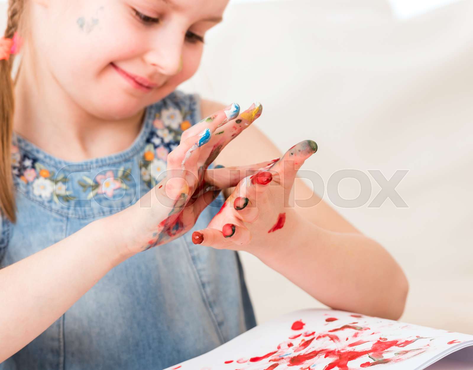 Child mixing colors at her hands | Stock image | Colourbox