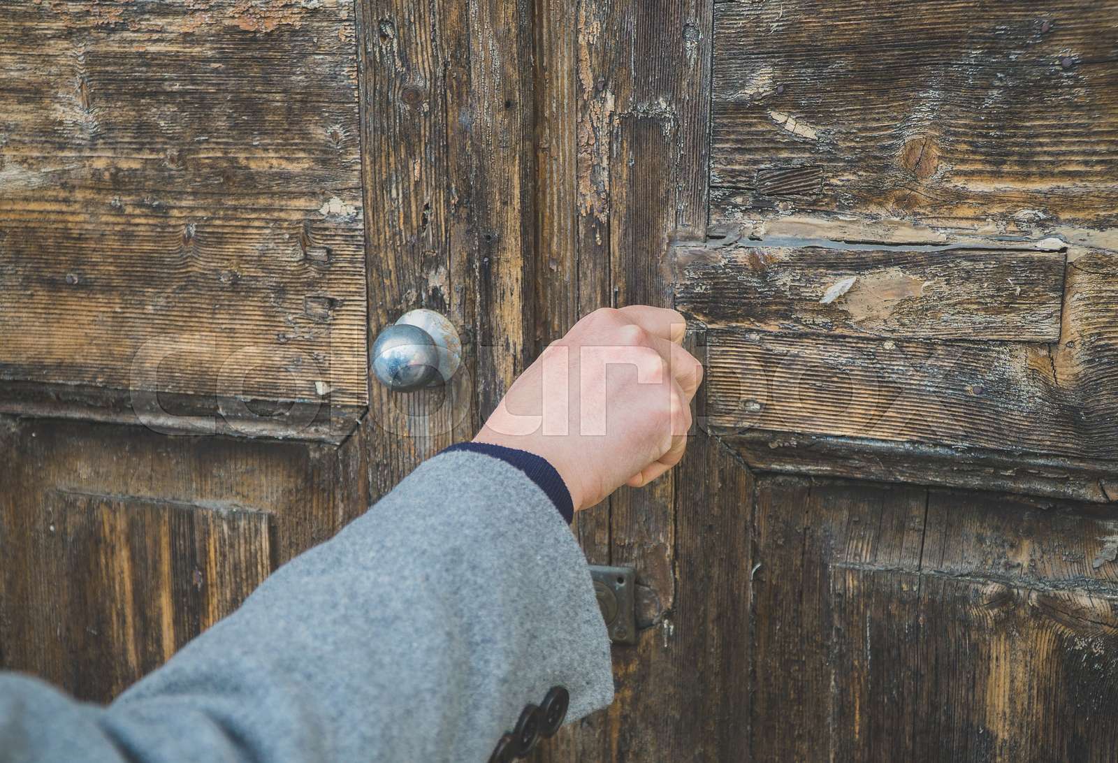 Woman opening very old wooden door. | Stock image | Colourbox