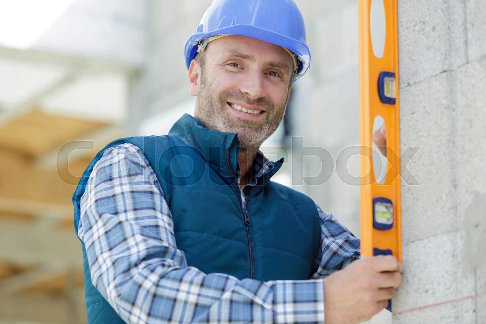 portrait of a builder man with level | Stock image | Colourbox