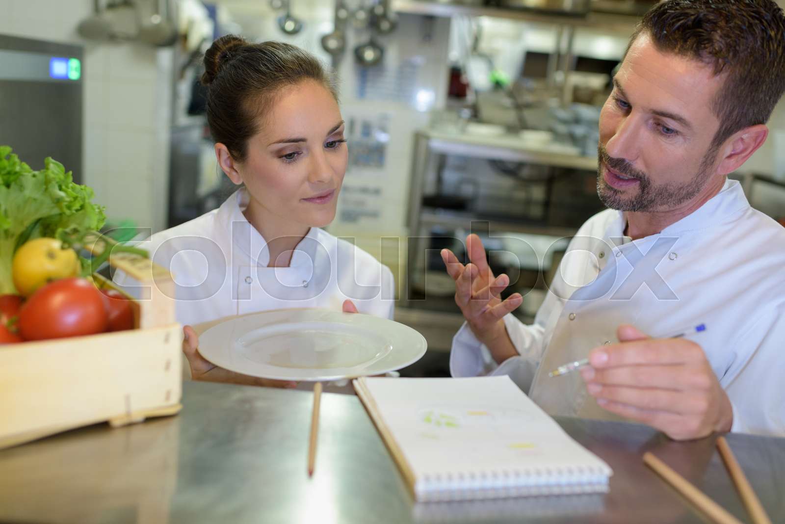 kitchen staff and chef having conversation | Stock image | Colourbox