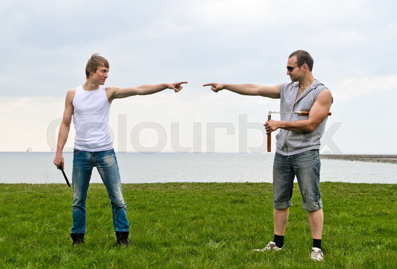 Opposition: Two fighters show at each other | Stock image | Colourbox
