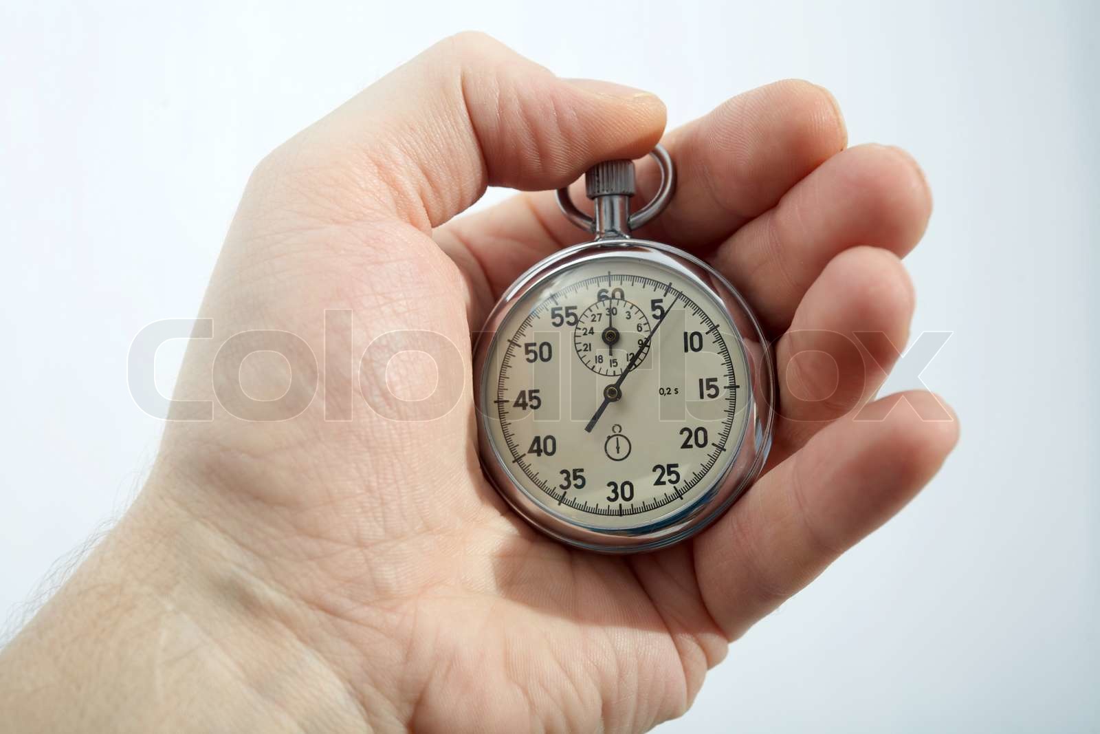 Stopwatch in a hand | Stock image | Colourbox