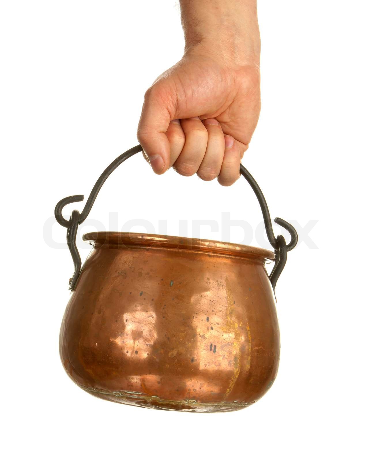 Hand holding bronze pot | Stock image | Colourbox