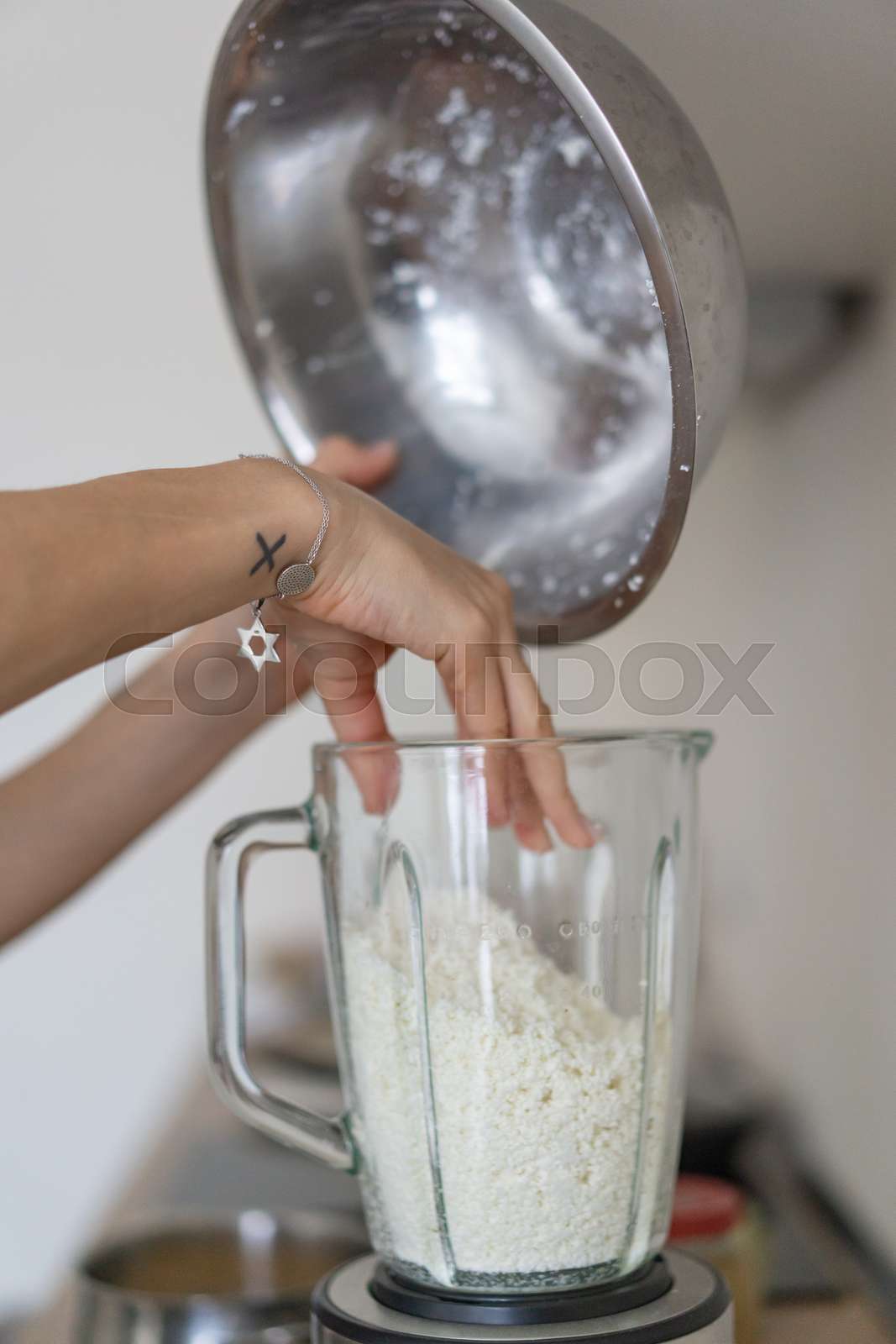 Woman pouring cottage cheese into a blender in the kitchen | Stock ...