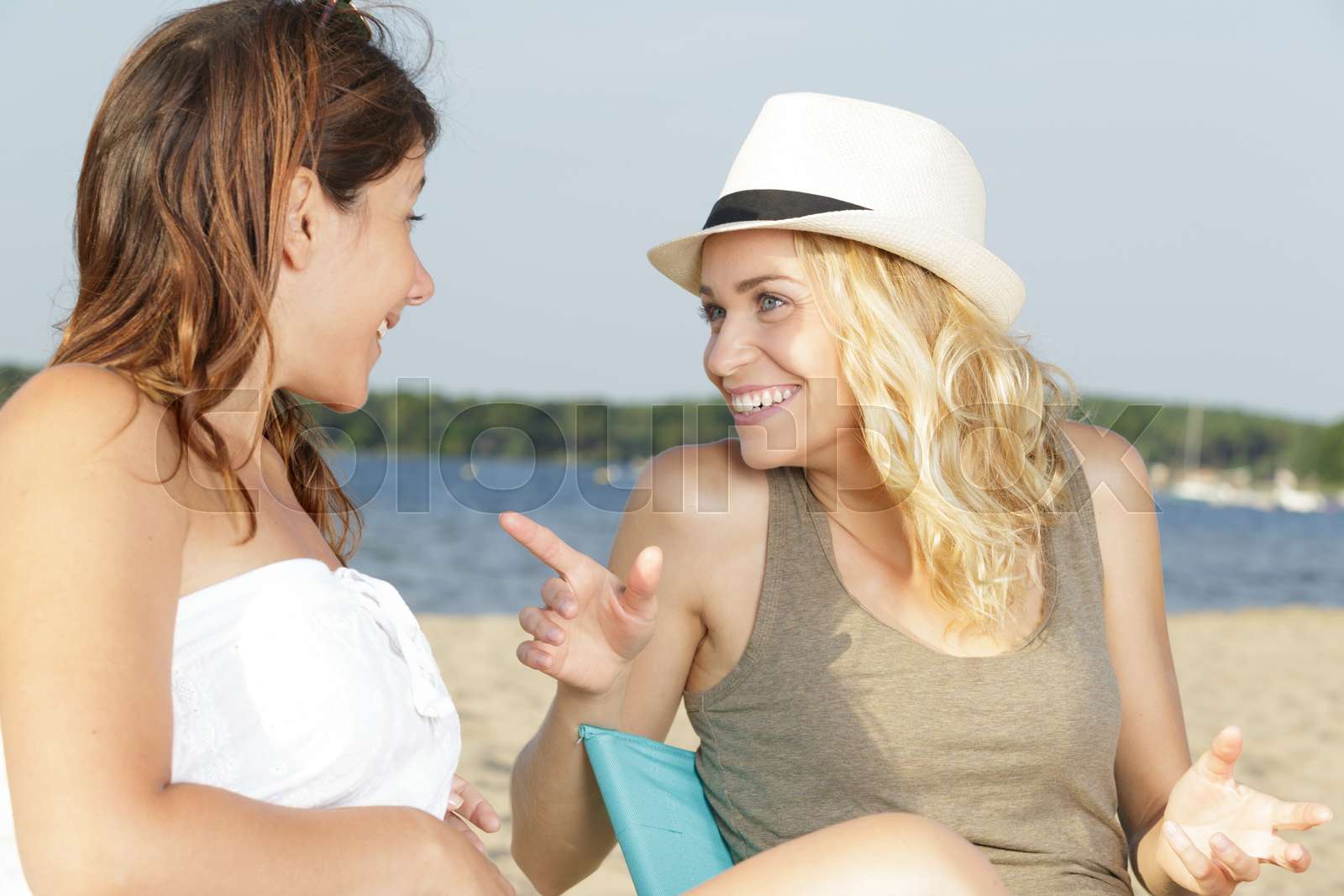 Two Women Talking On The Beach Stock Image Colourbox