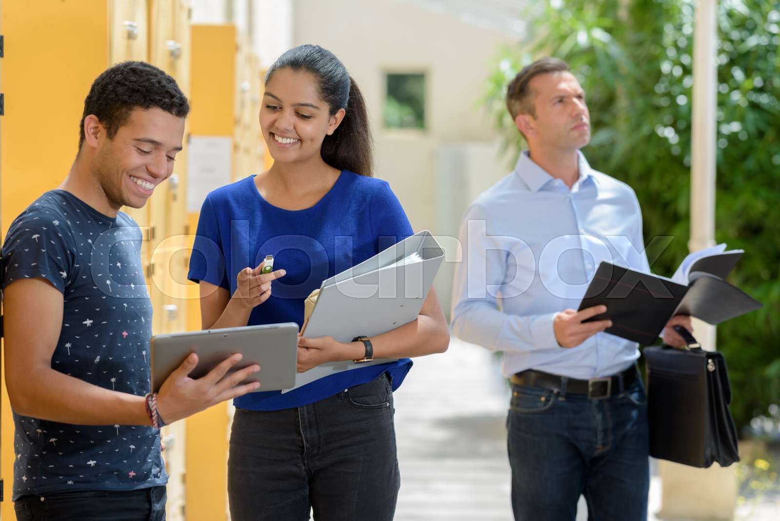student group socializing outside college buildings | Stock image ...