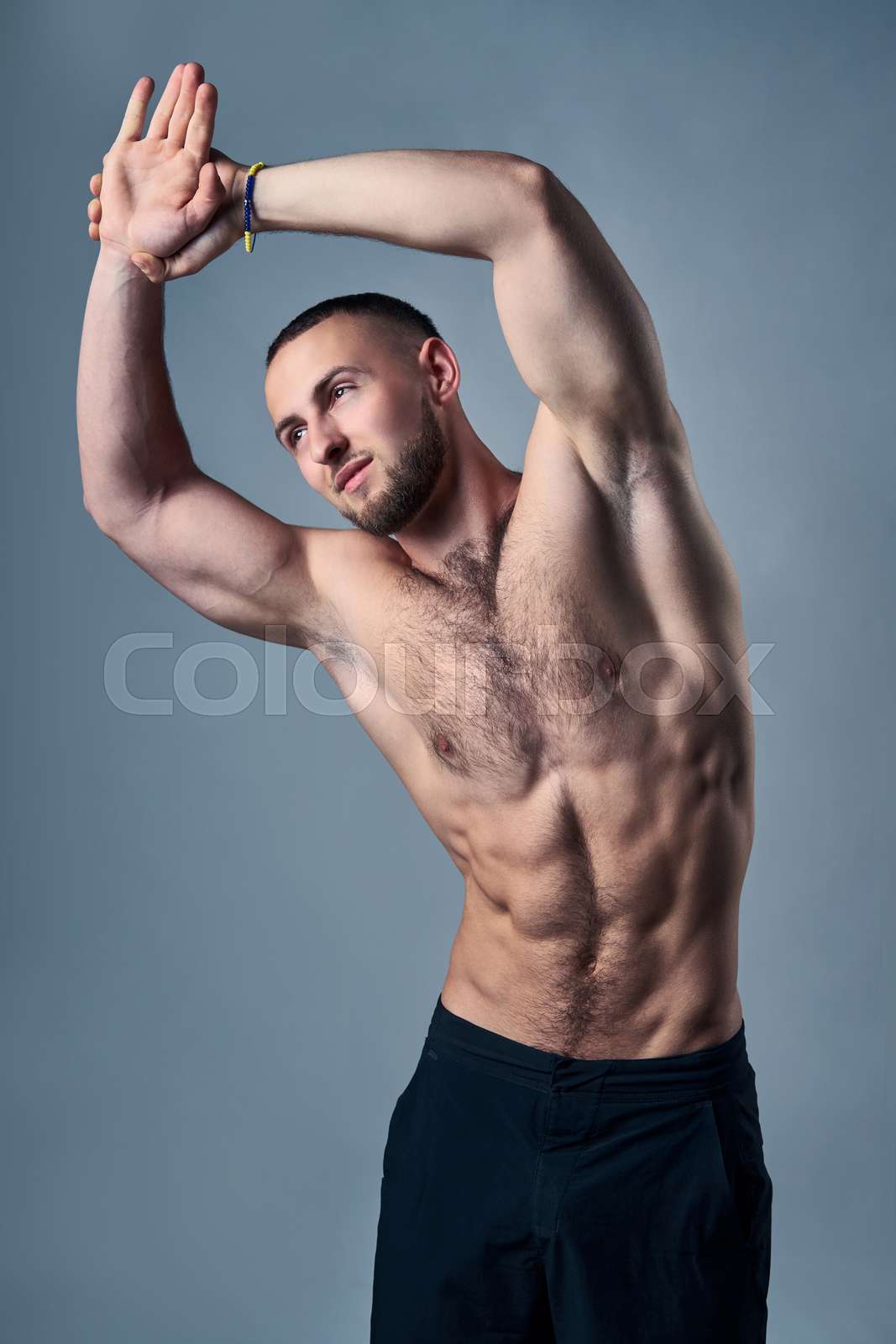 Muscular shirtless man stretching | Stock image | Colourbox