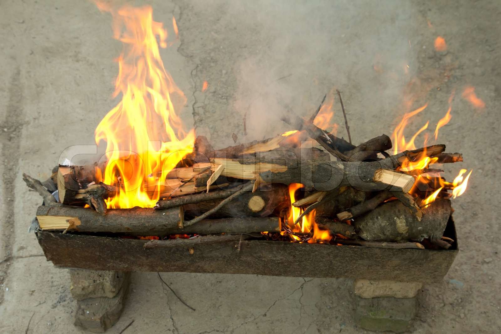 Fire, burning branches of a tree on a barbecue | Stock image | Colourbox