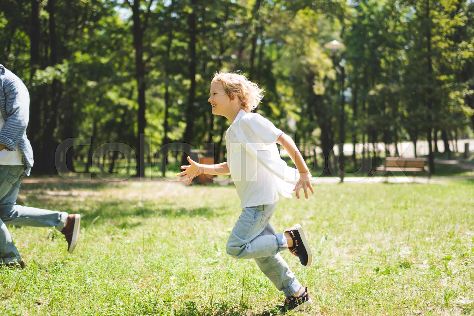 happy son running with father in park during daytime | Stock image ...
