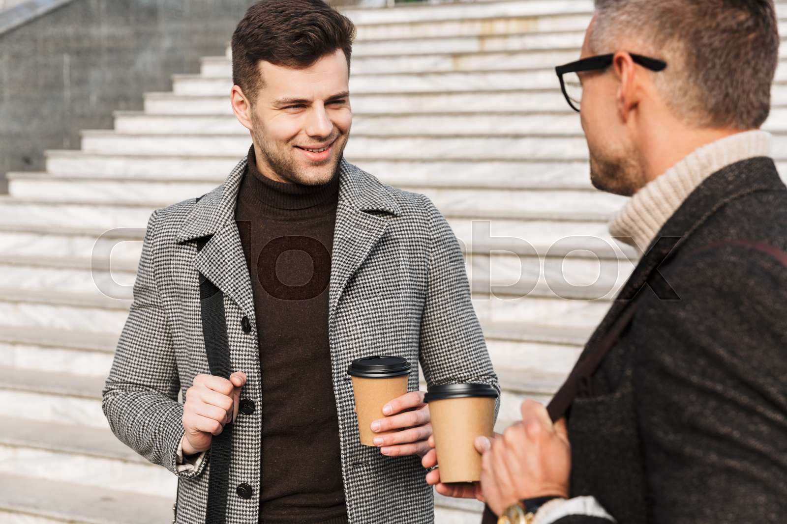 Two handsome men wearing coats spending time | Stock image | Colourbox