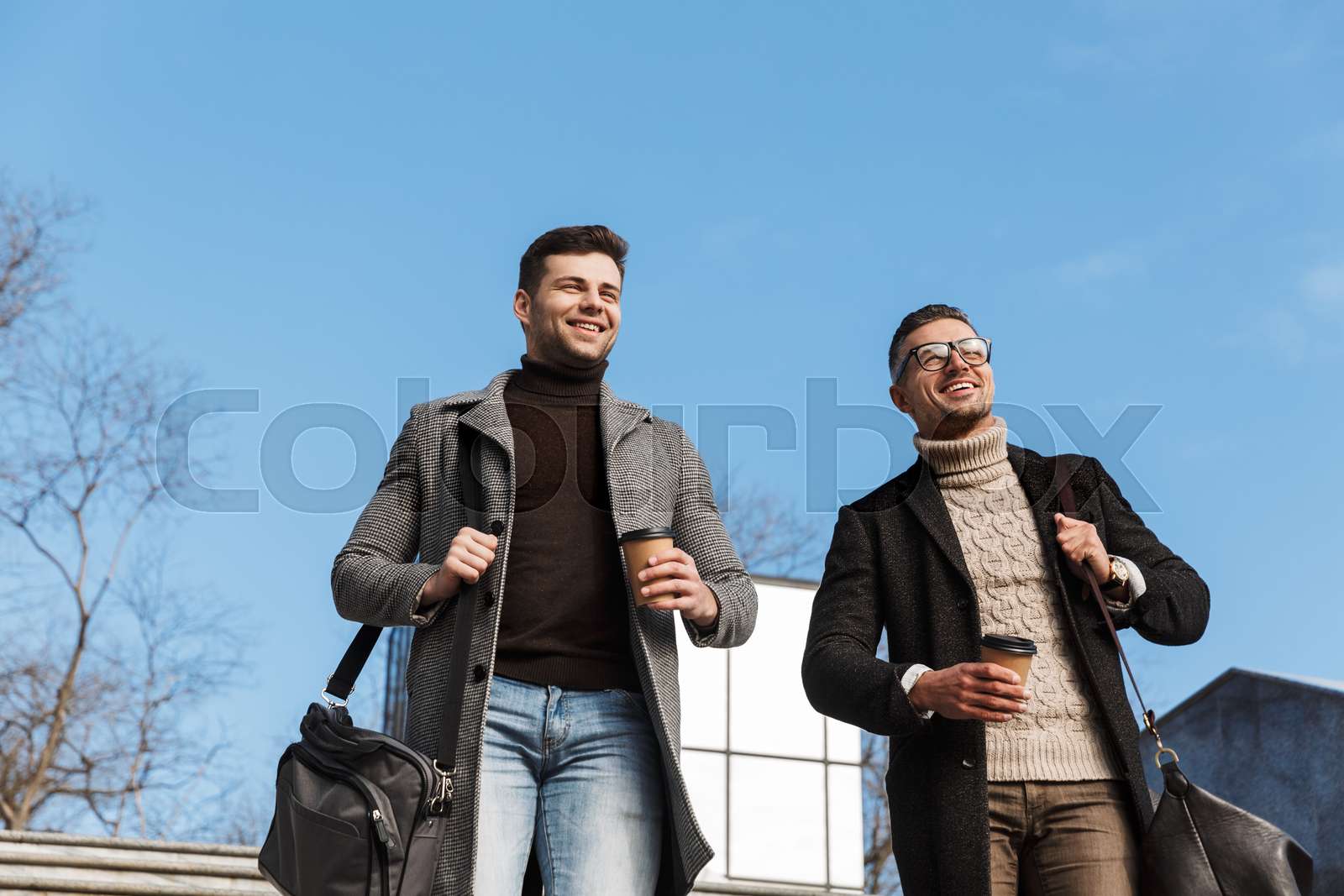Two handsome men wearing coats spending time | Stock image | Colourbox