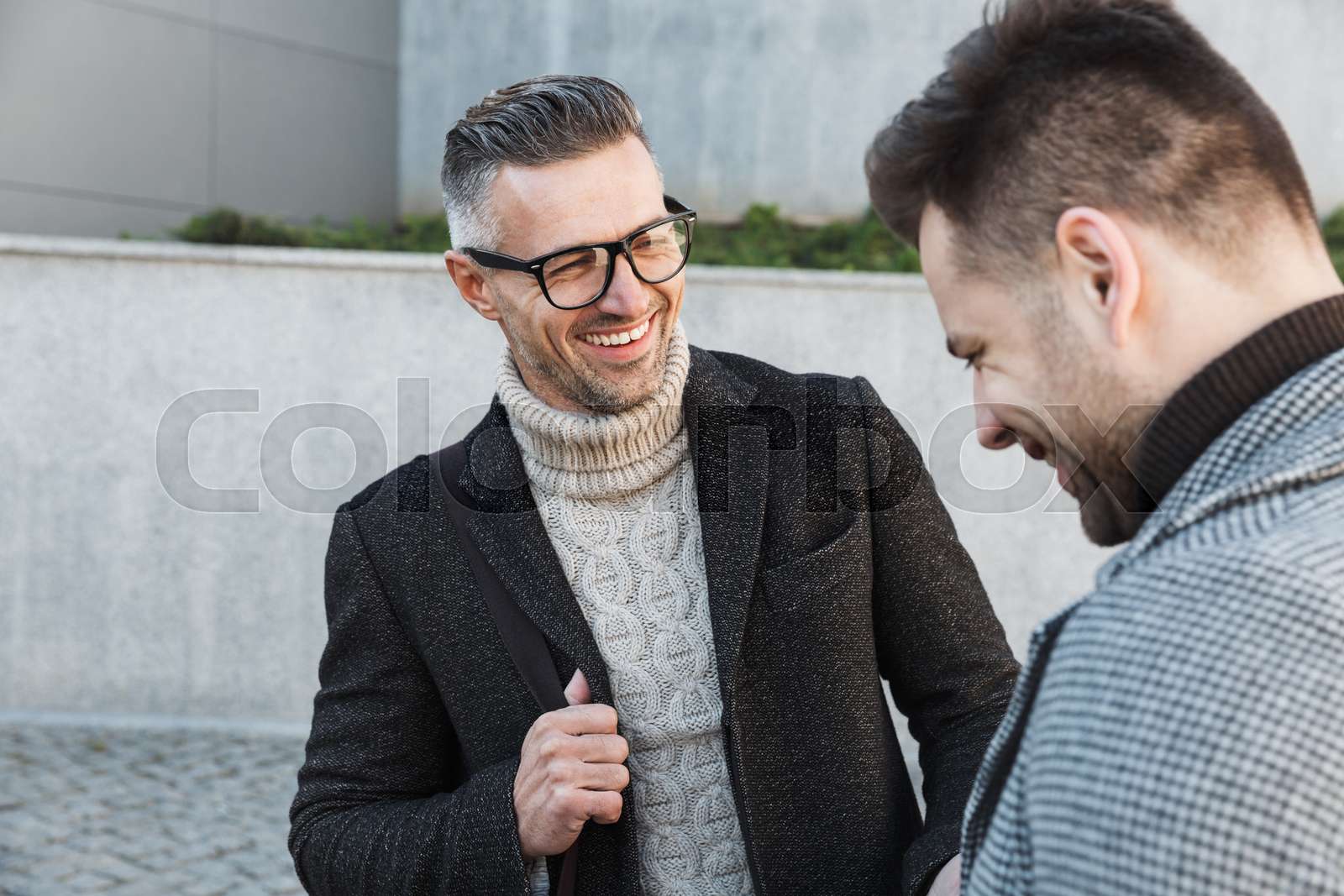 Two handsome men wearing coats spending time | Stock image | Colourbox