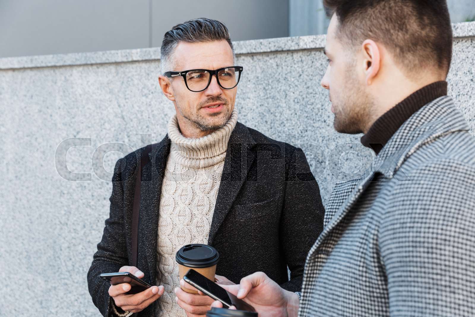 Two handsome men wearing coats spending time | Stock image | Colourbox