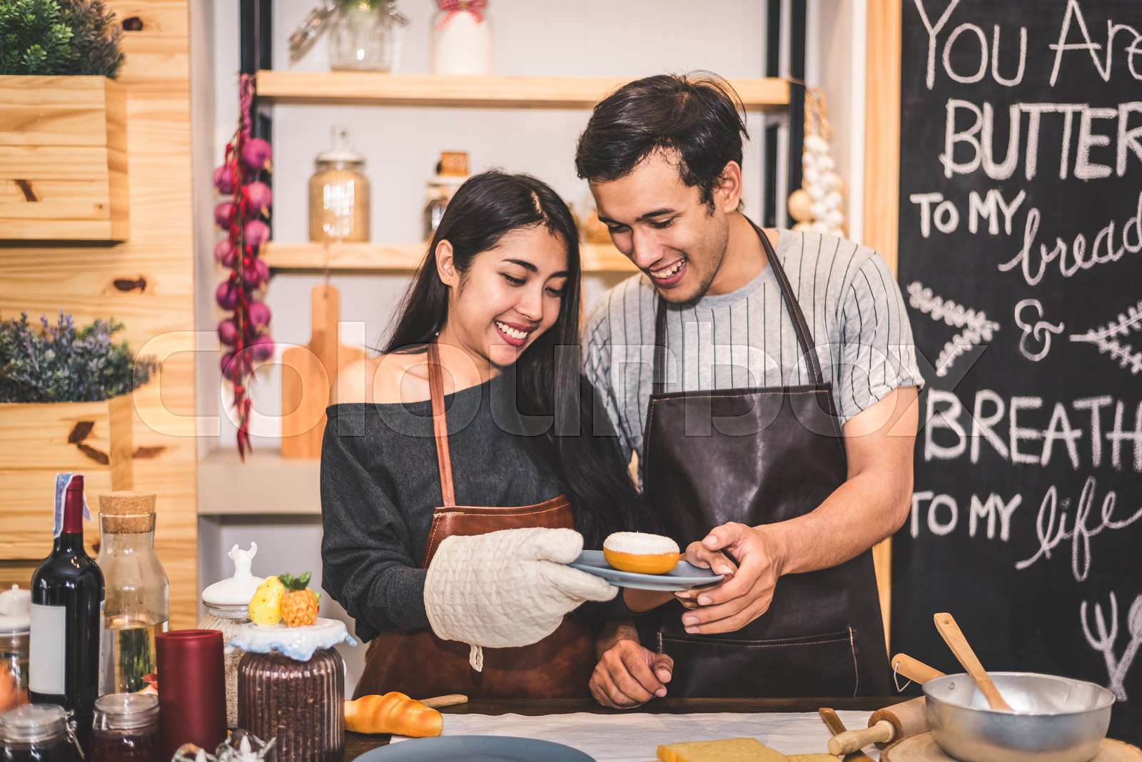 Young couples making bakery donuts and bread at bakery shop as business ...