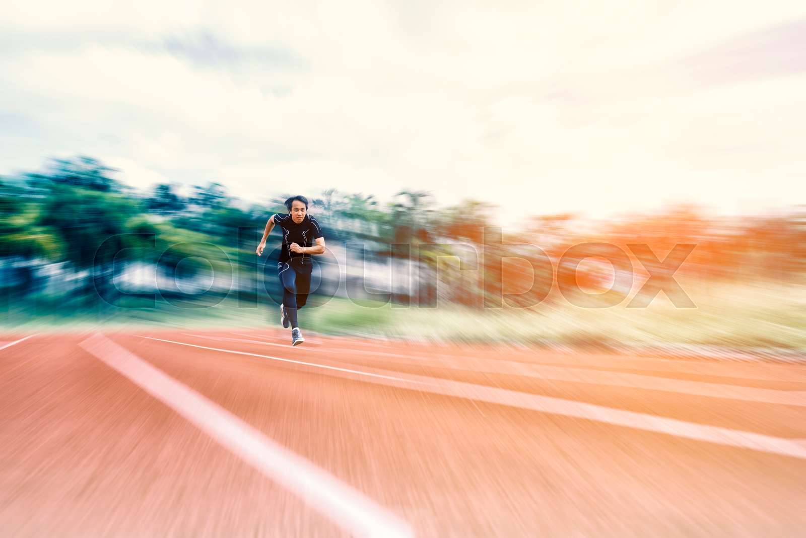Running Man running on the track with radial blur, Sport and Activity ...