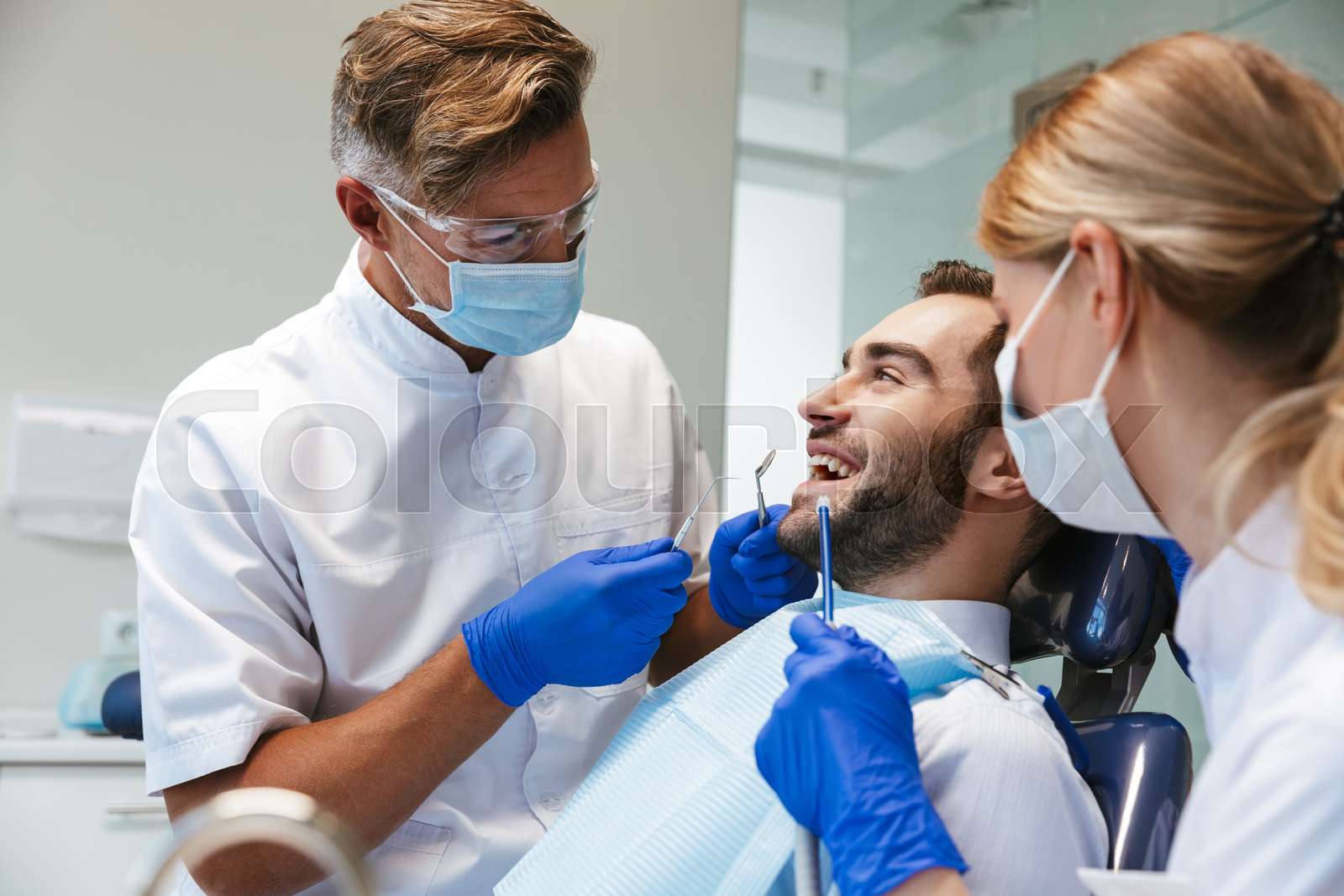 Handsome happy young man sitting in medical dentist center. | Stock ...