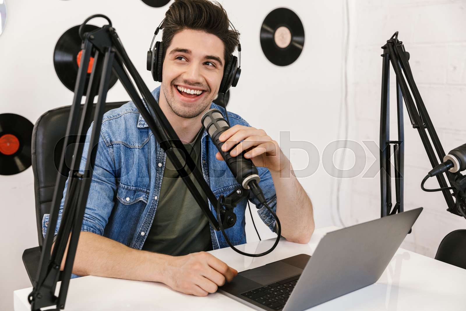 Cheerful young man radio host broadcasting | Stock image | Colourbox