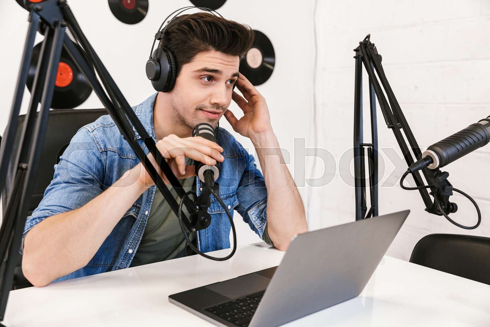 Cheerful young man radio host broadcasting | Stock image | Colourbox