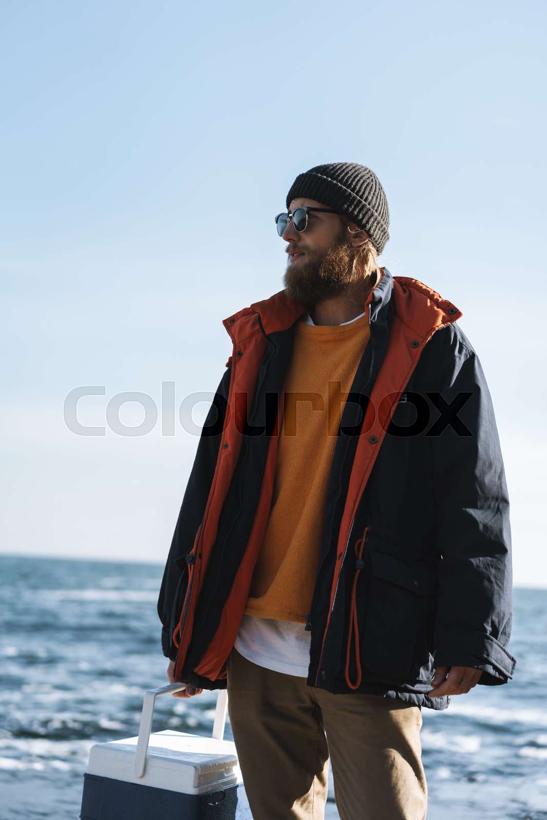 Fisherman wearing coat standing at the seashore | Stock image | Colourbox