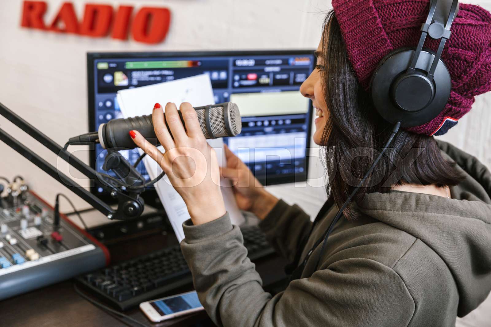 Cheerful young woman radio host broadcasting | Stock image | Colourbox