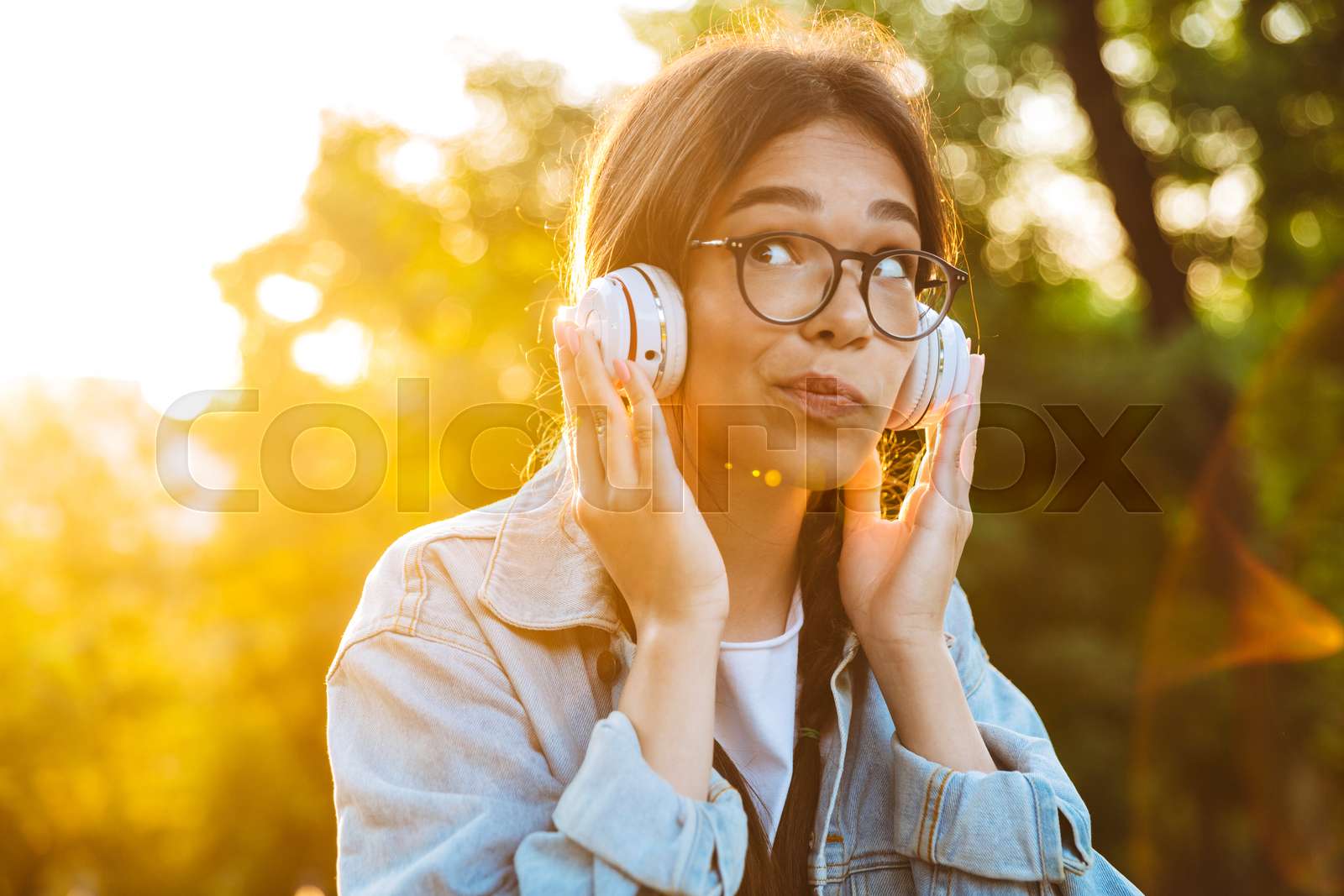 Thinking young teenage girl student sitting outdoors in beautiful green ... Thinking young teenage girl student sitting outdoors in beautiful green ...