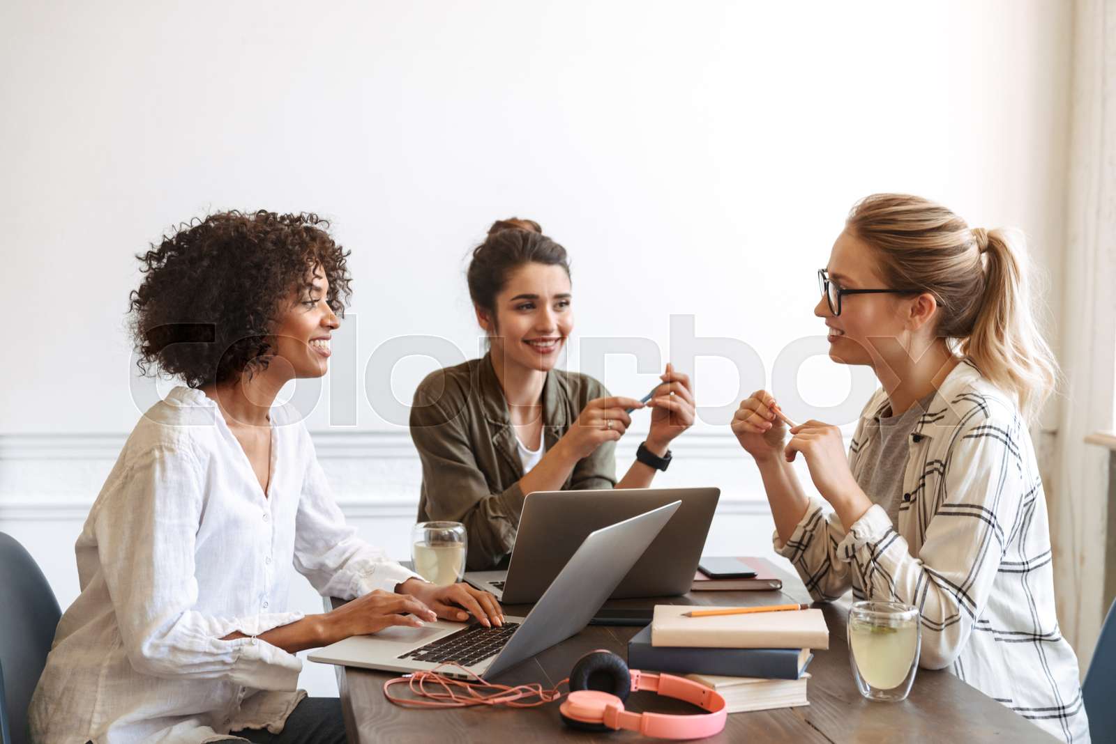 Group of cheerful young women studying together | Stock image | Colourbox