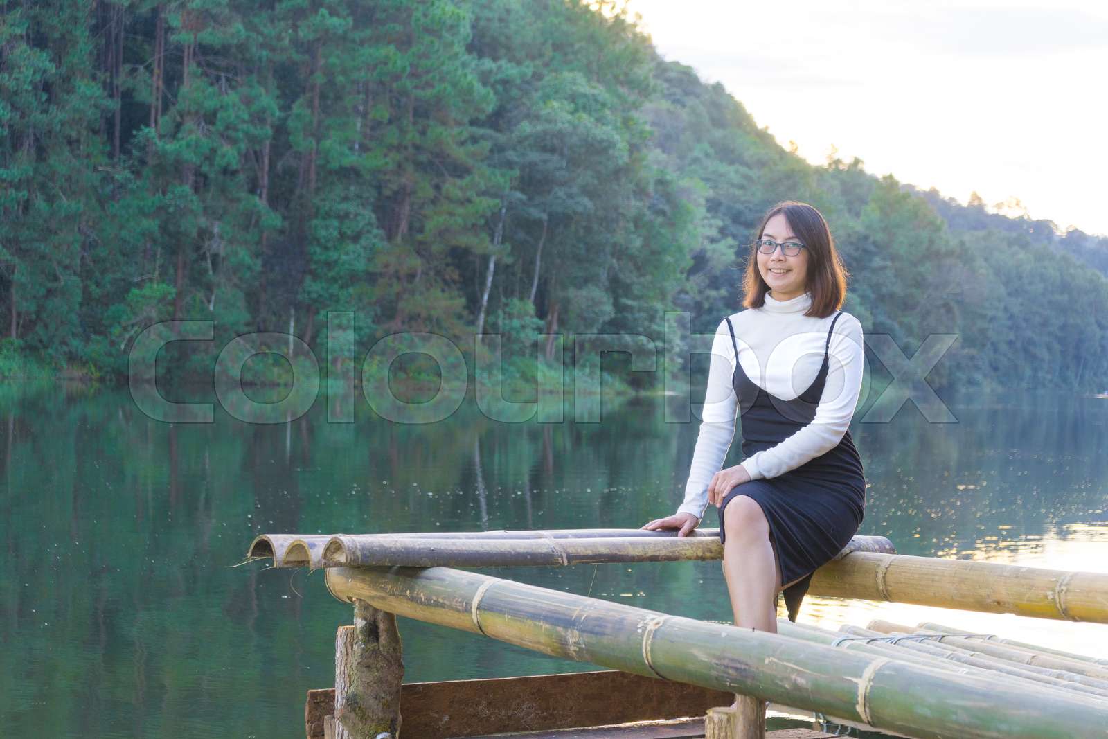 Asian woman sitting on raft. | Stock image | Colourbox