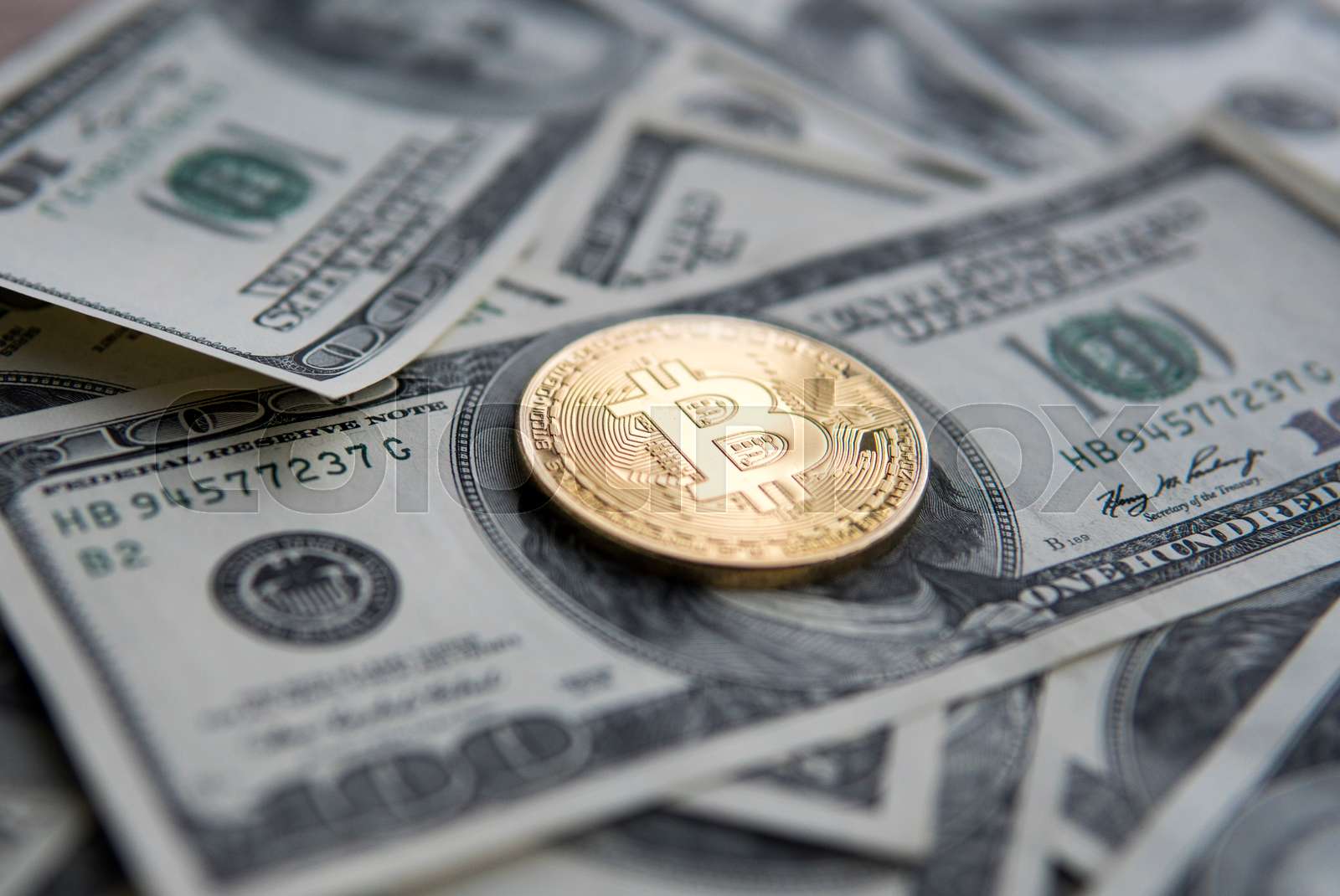 Golden Bitcoins on US dollars. Digital currency close-up. New virtual ...