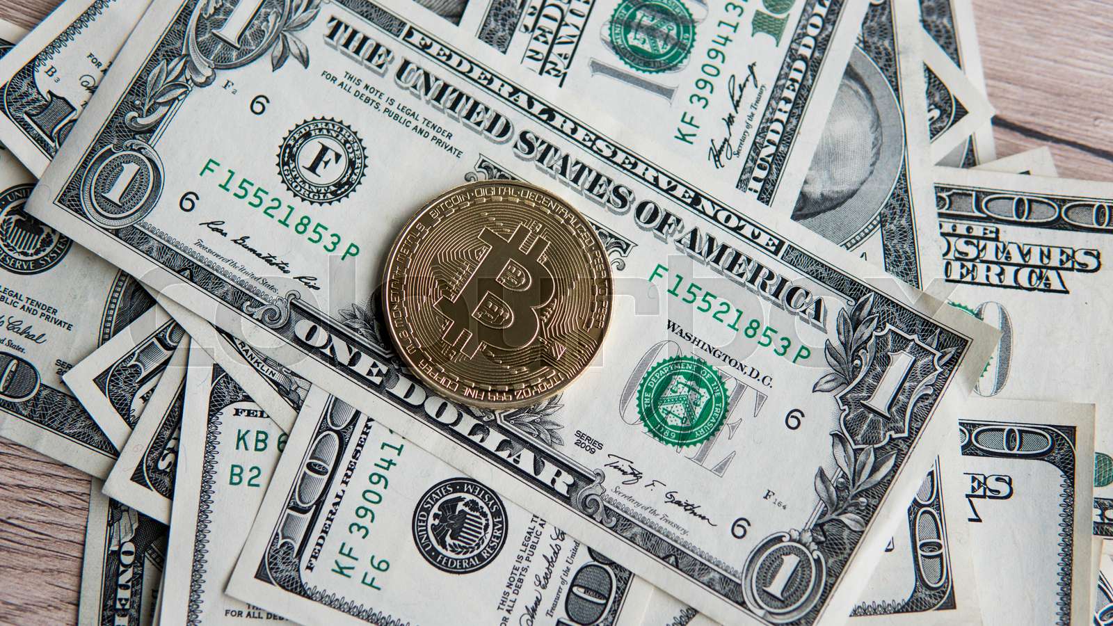 Golden Bitcoins on US dollars. Digital currency close-up. New virtual ...