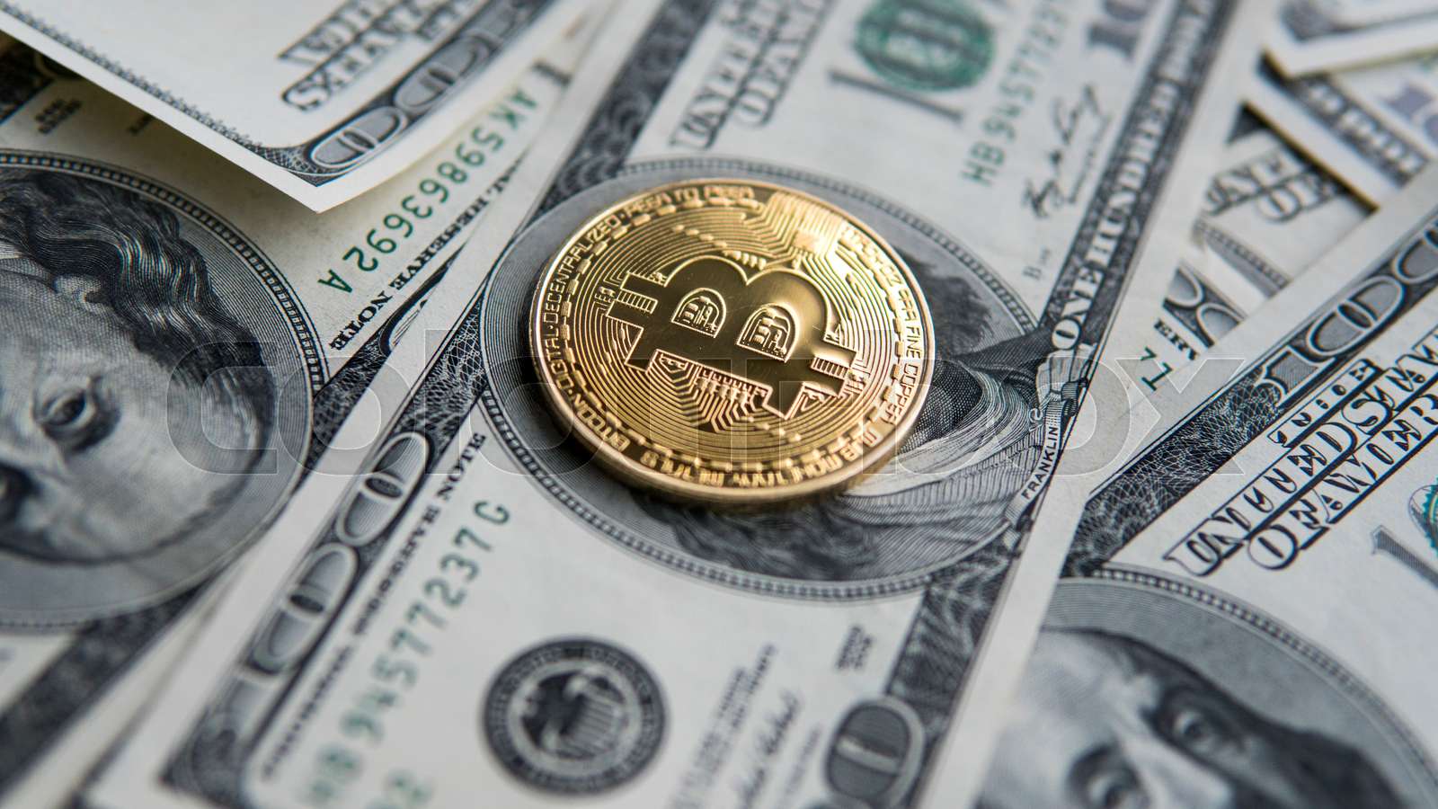 Golden Bitcoins on US dollars. Digital currency close-up. New virtual ...