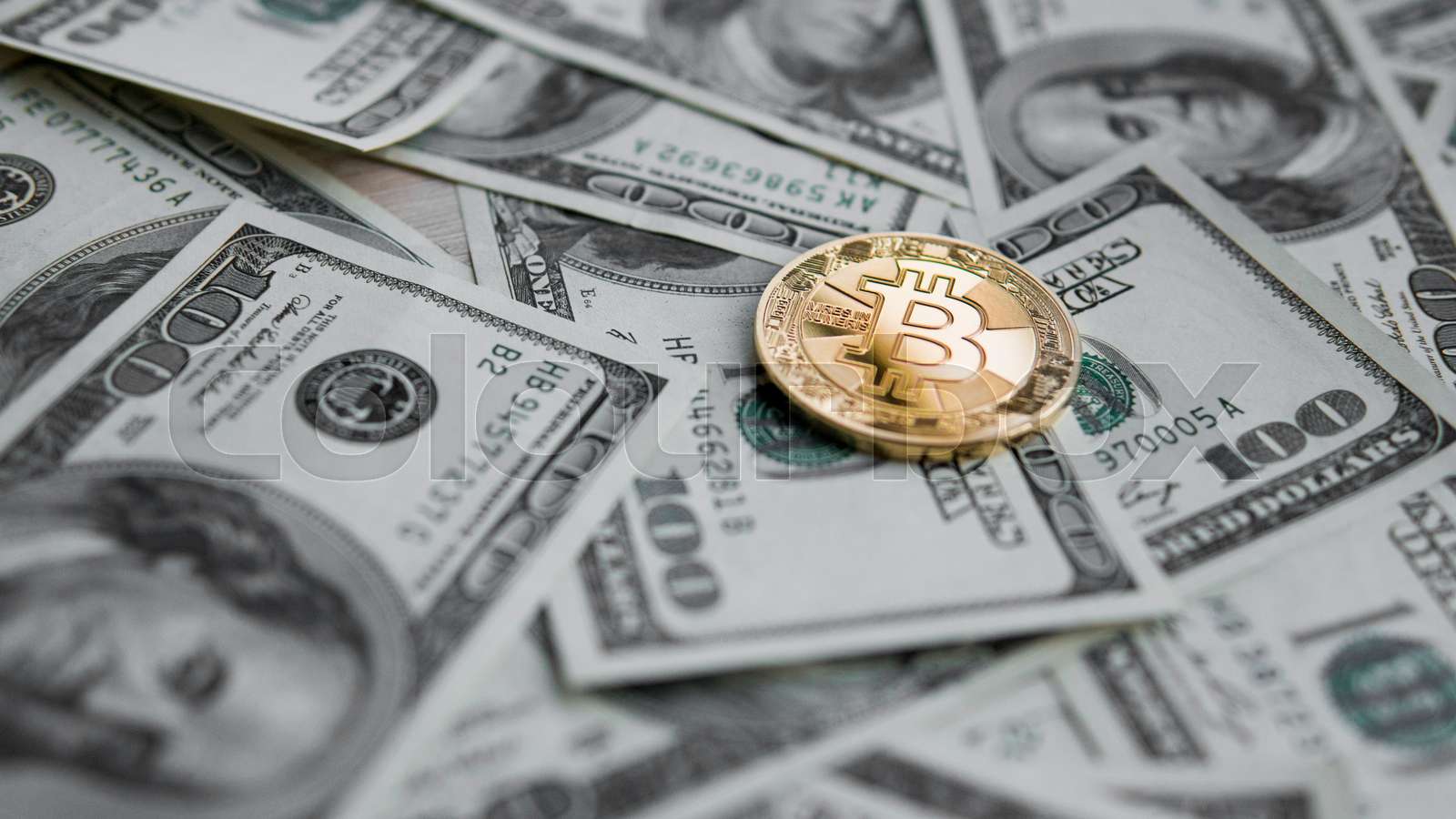 Golden Bitcoins on US dollars. Digital currency close-up. New virtual ...