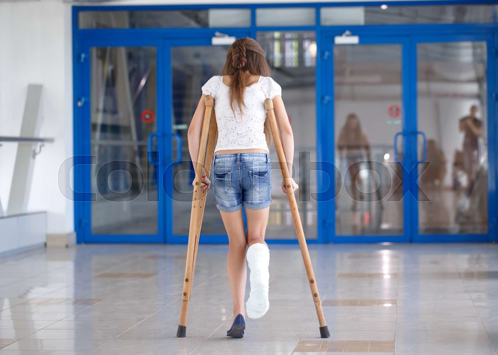 A Young Girl Is On Crutches In The Corridor Of The Hospital Stock Image Colourbox