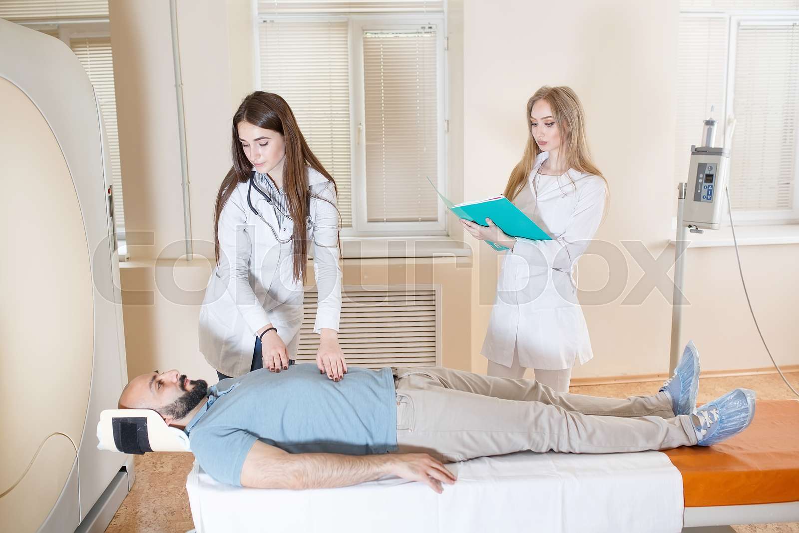 Happy patient undergoing mri scan at hospital. | Stock image | Colourbox