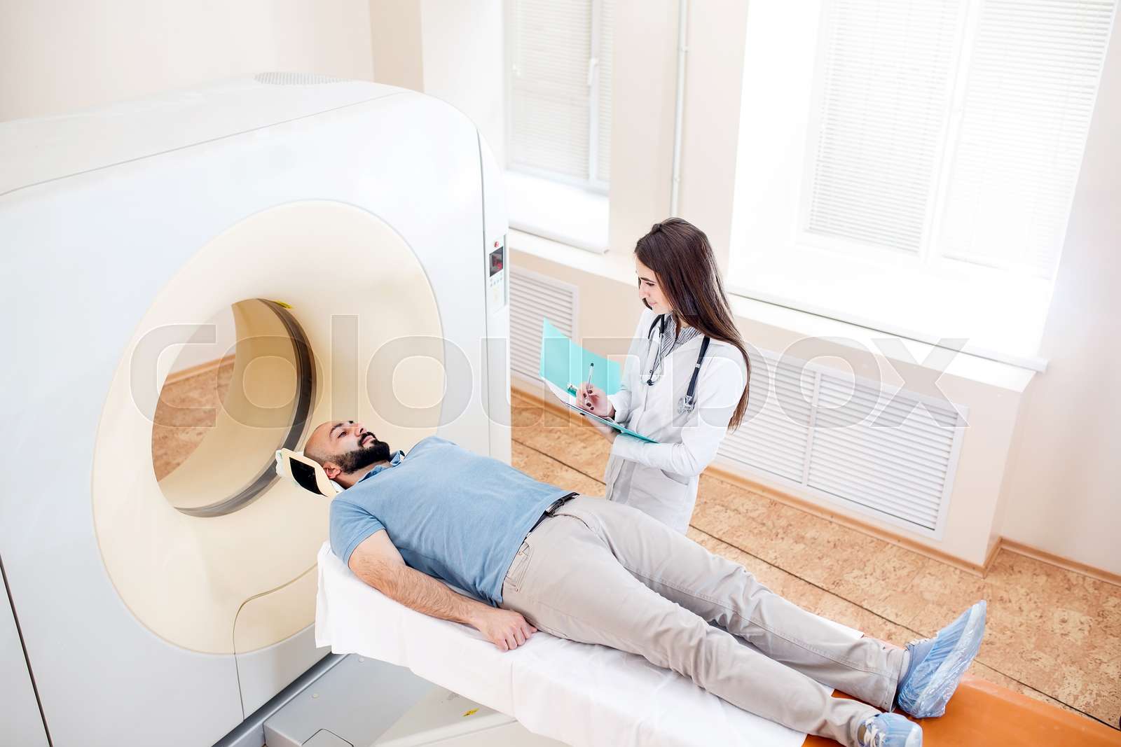 Happy patient undergoing mri scan at hospital. | Stock image | Colourbox