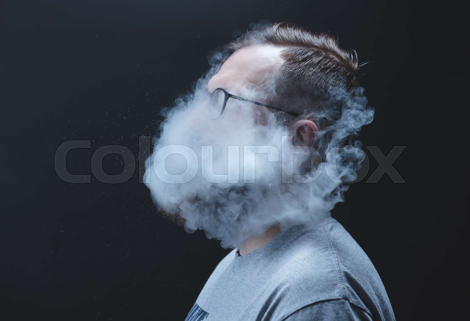 Concept. Smoke enveloped the head man. Portrait of a Bearded, stylish ...
