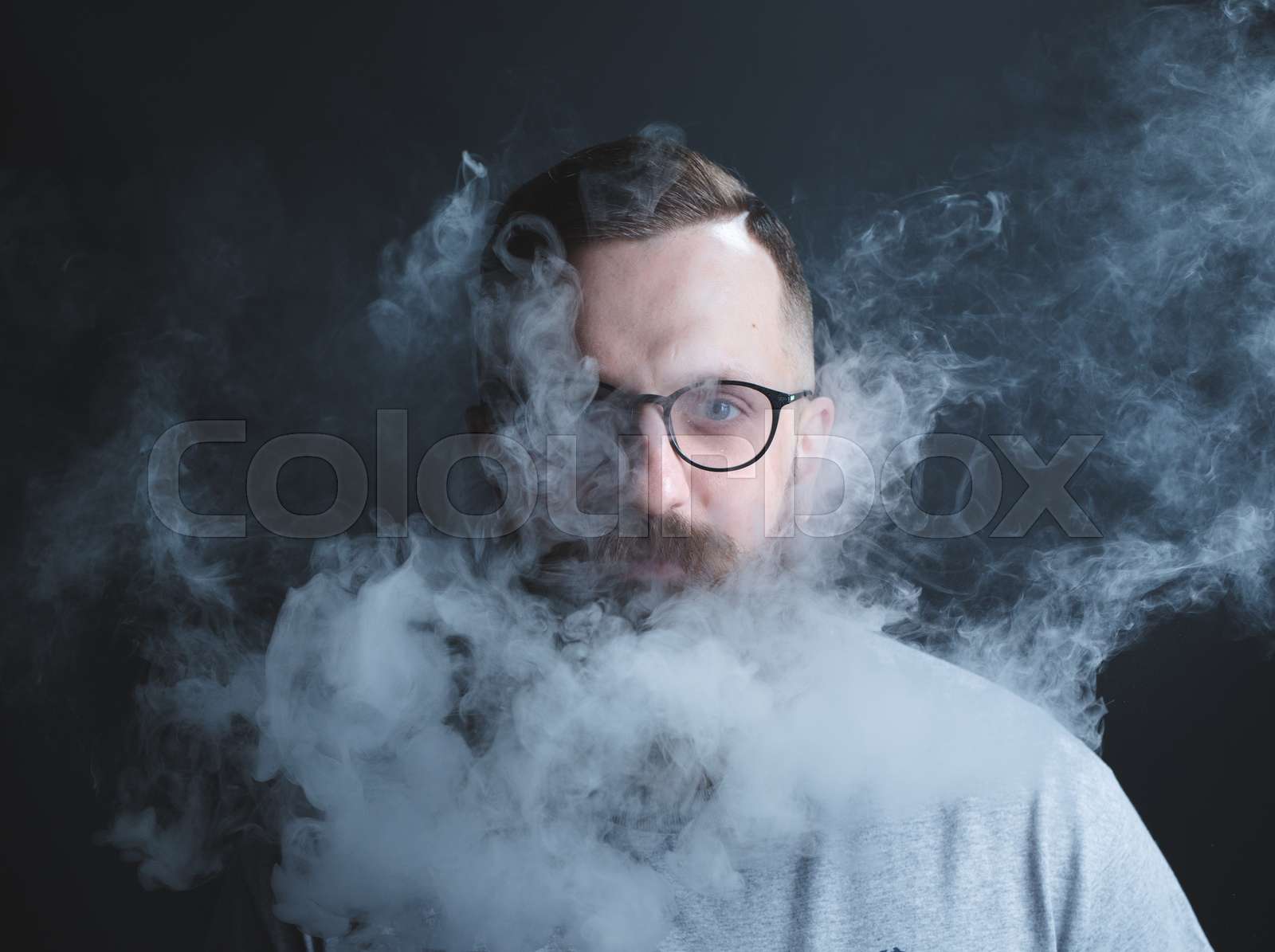 Concept. Smoke enveloped the head man. Portrait of a Bearded, stylish ...