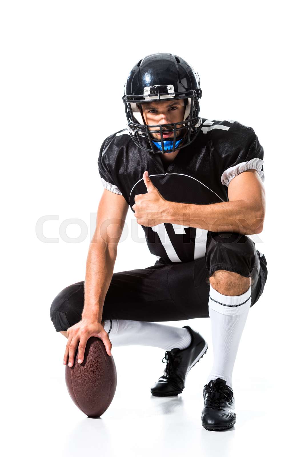 American Football player with ball doing thumb up sign On White | Stock ...