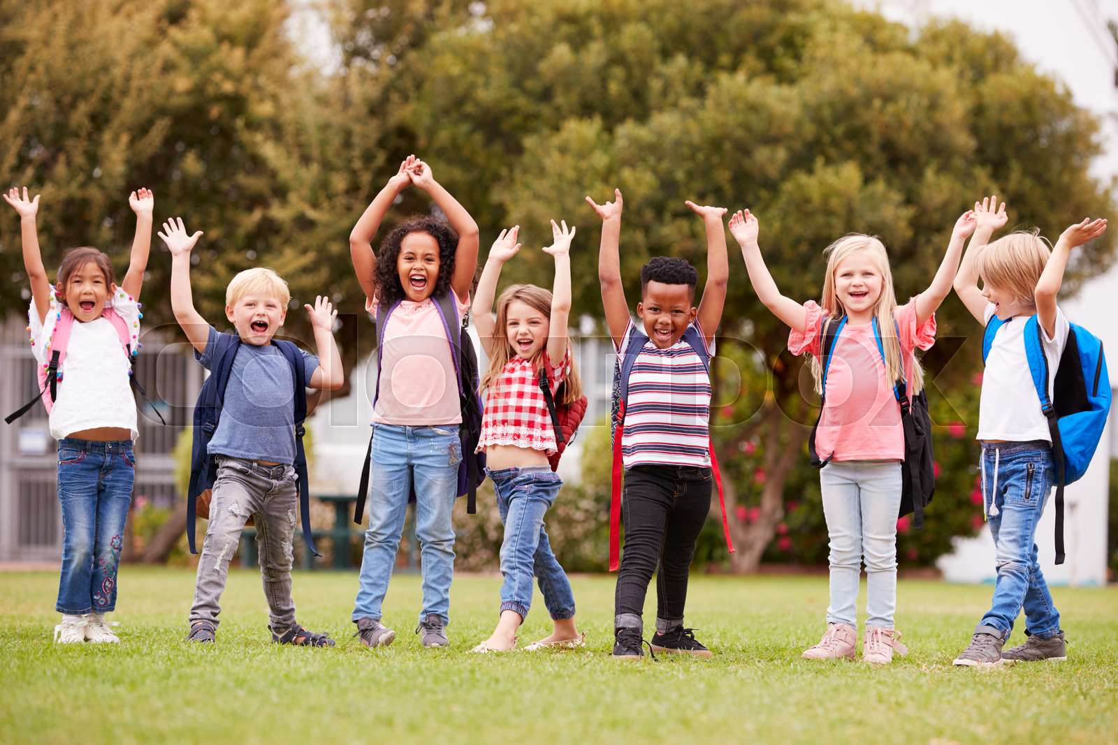 Excited Elementary School Pupils On Playing Field At Break Time | Stock ...