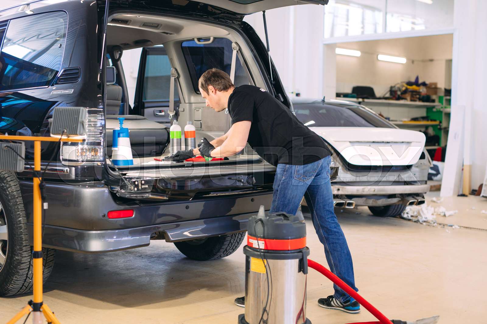 Car chemist. Chemical treatment of the car trunk. | Stock image | Colourbox